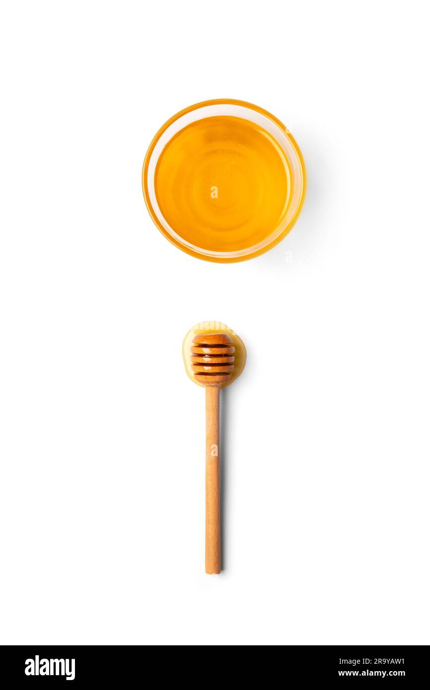 Creative composition, a wooden dipper lies in a drop of honey and a ...