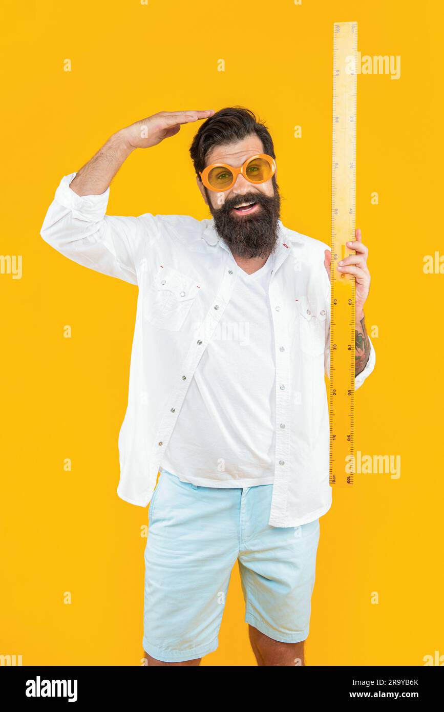 school man measure height with ruler isolated on yellow. school man ...