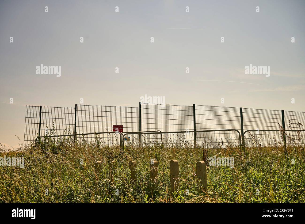 Fence at end of airport runway Stock Photo - Alamy