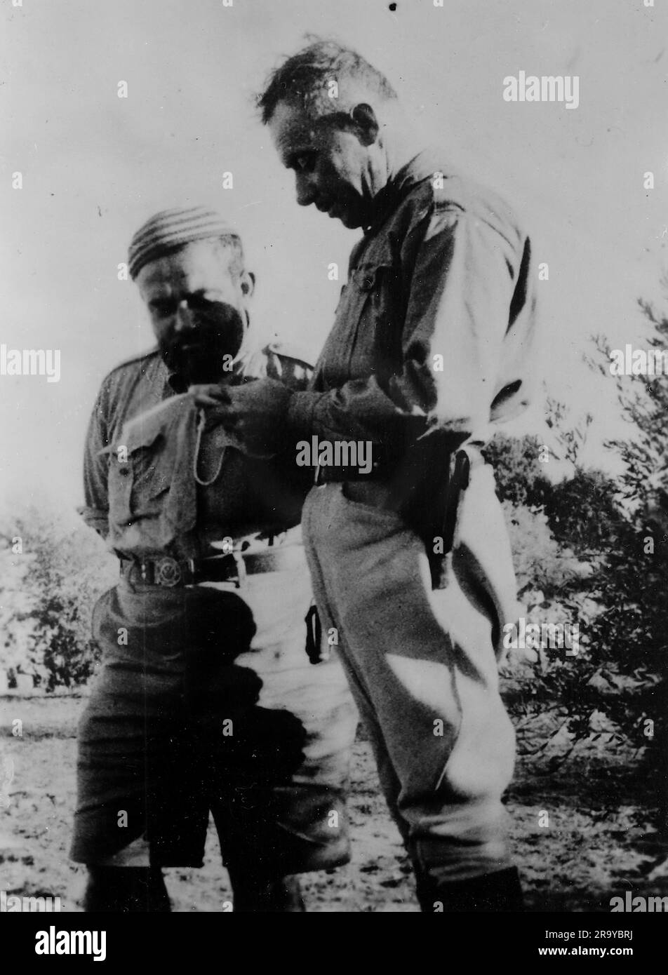 A British officer and an Arab, the latter part of a group described as ...