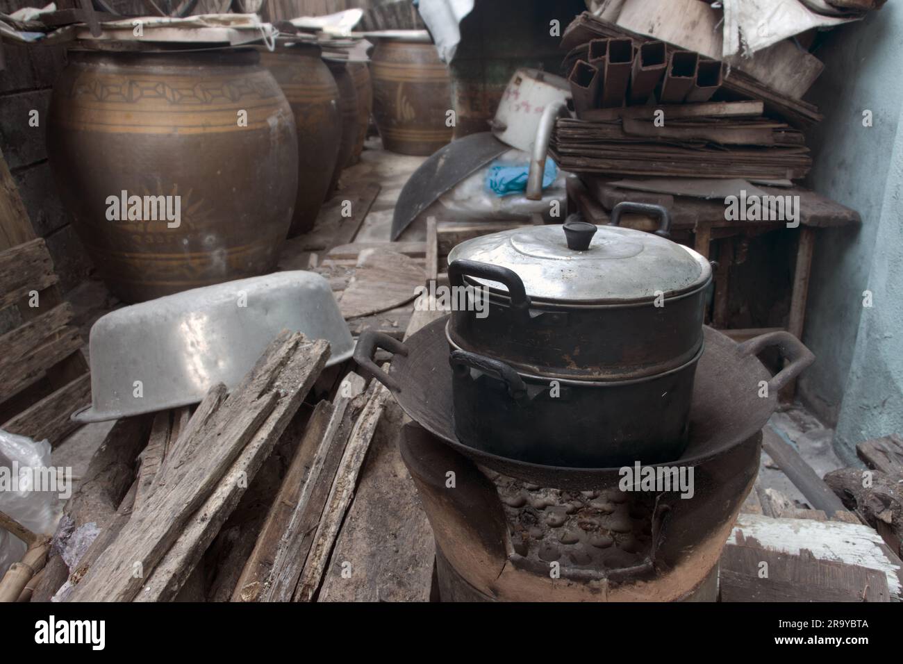 Traditional outdoor fire pit with dishware and wood in the backyard of ...