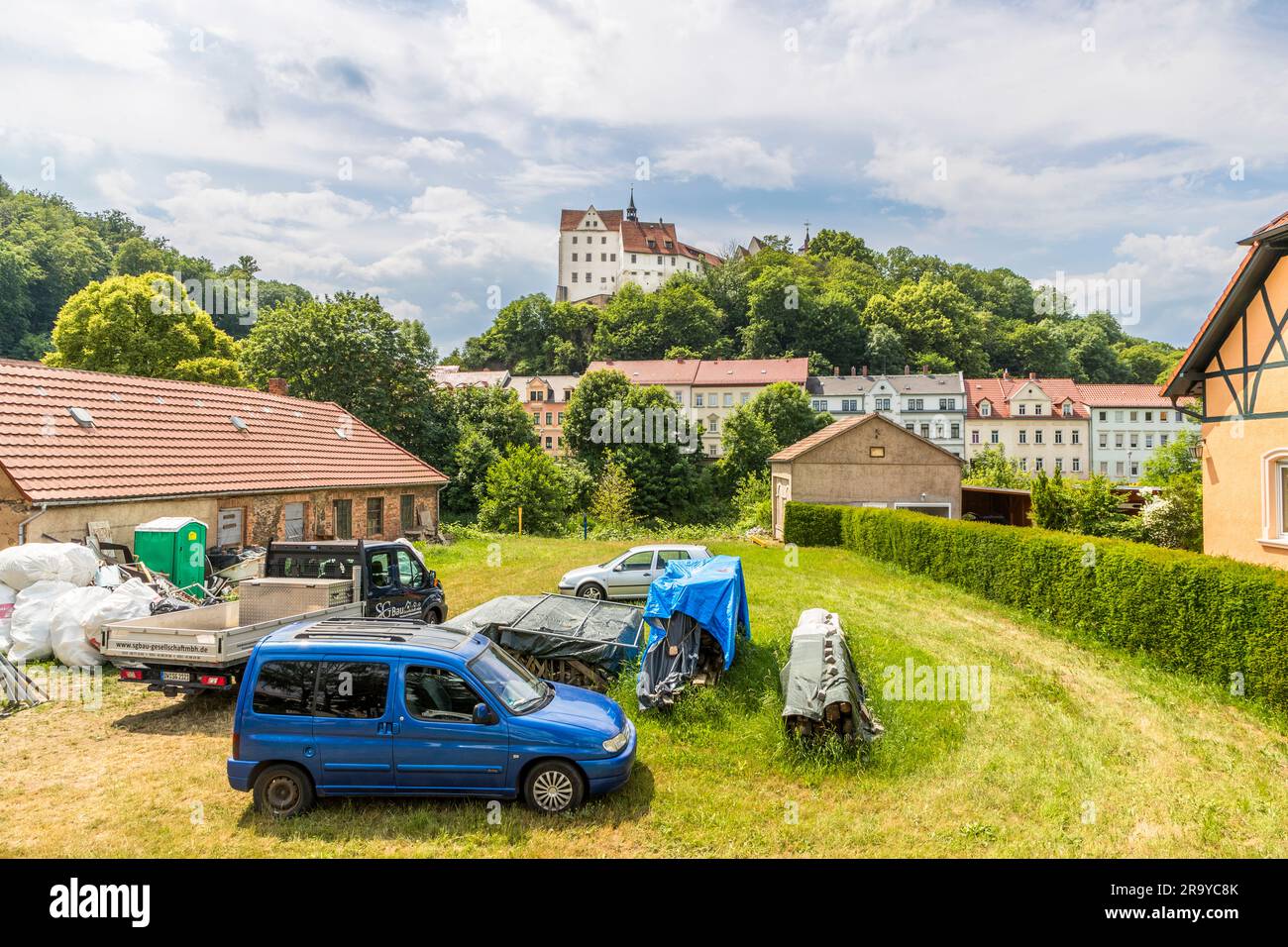 Yard and garage building with building material in the background ...