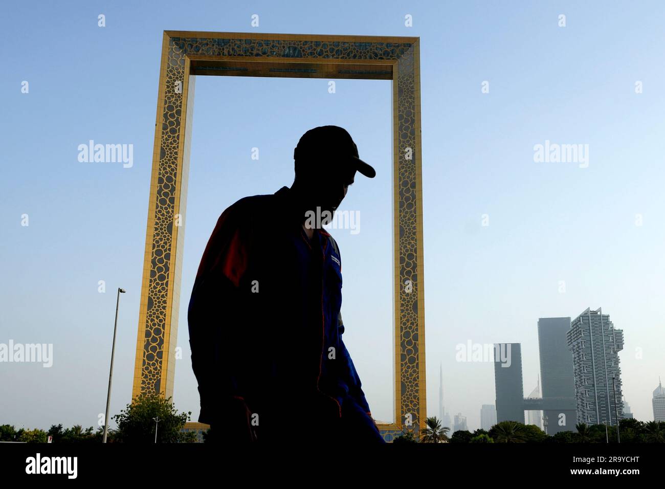 A man passes in front of the Dubai Frame in Dubai, United Arab Emirates ...