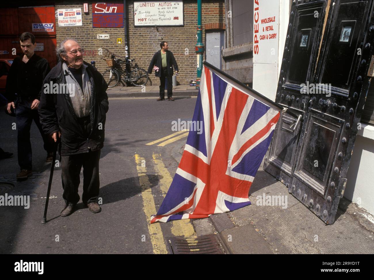 Sunday morning market in Brick Lane, Whitechapel. An older man wanders ...