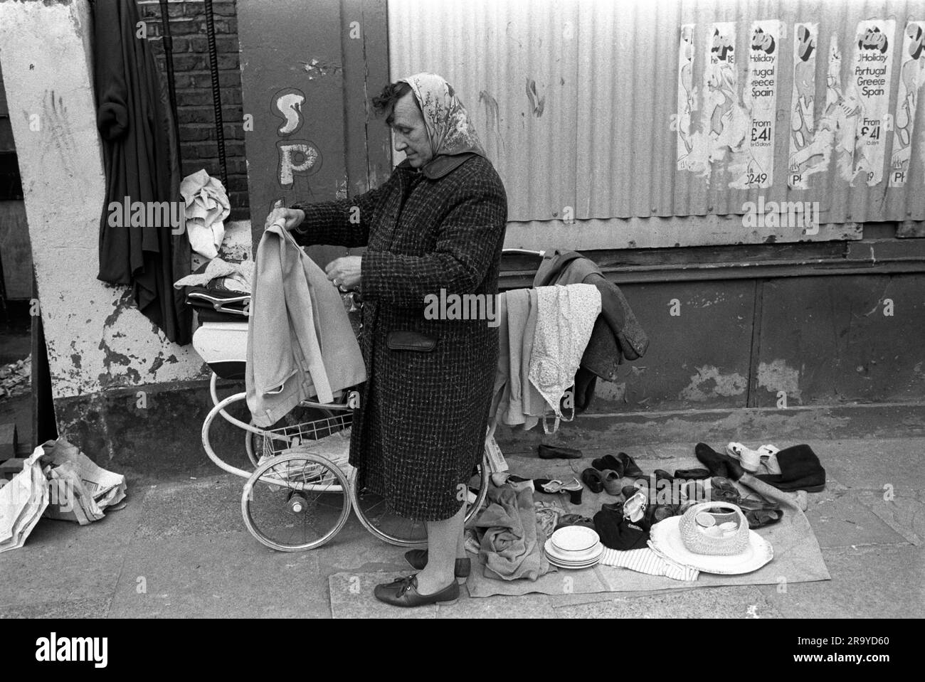 Out of work, poverty London 1970s UK. Unemployed woman sell old clothes ...