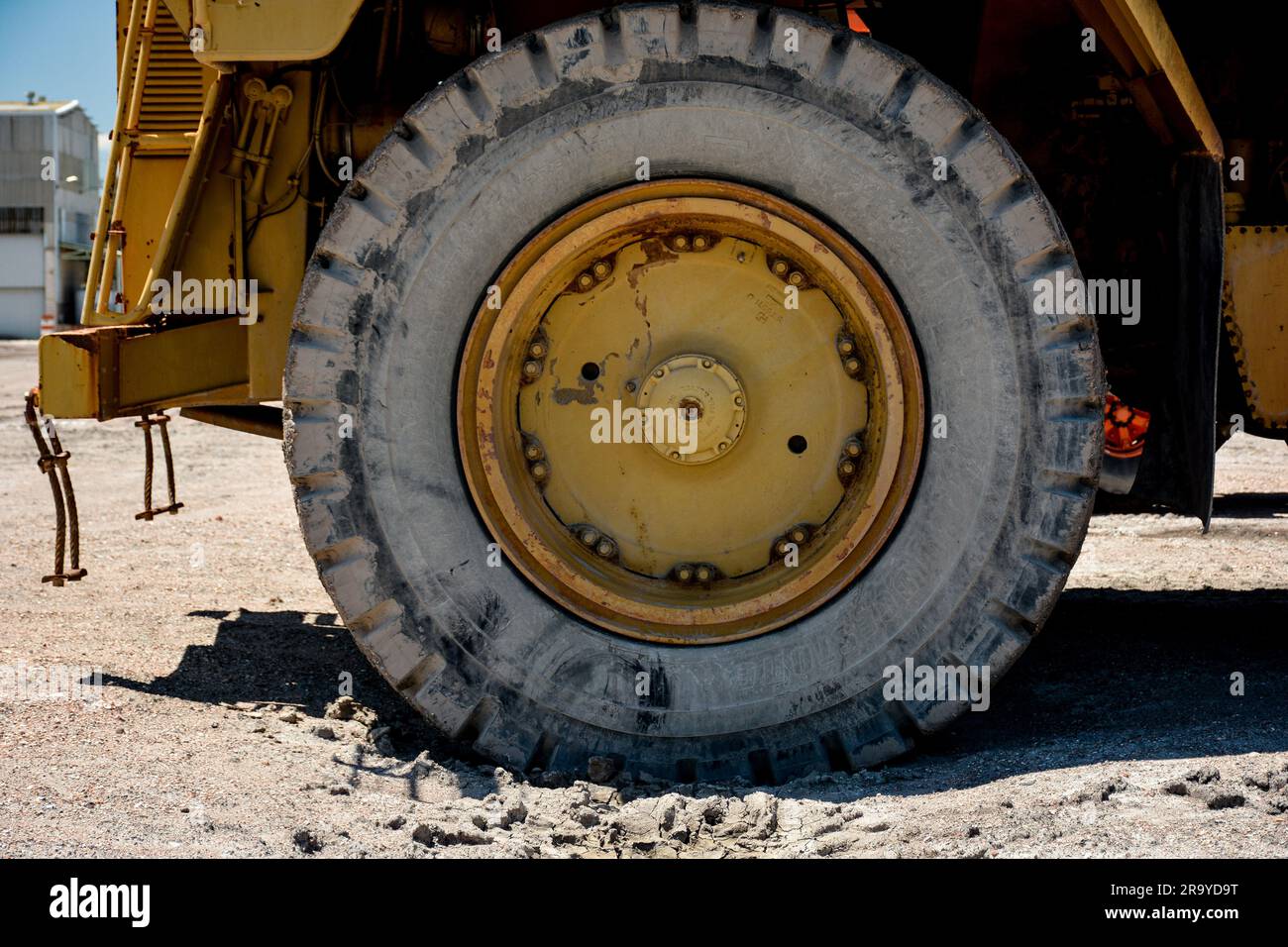 A closeup shot of an old dirty tire on a rusty truck for coal mine ...