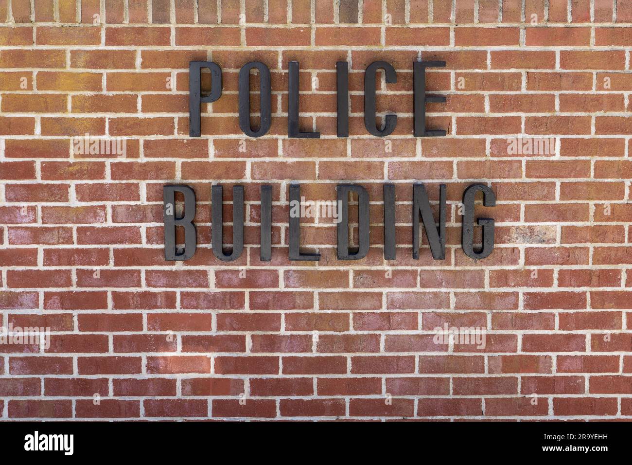 Police Building black letters on a red brick wall Stock Photo - Alamy