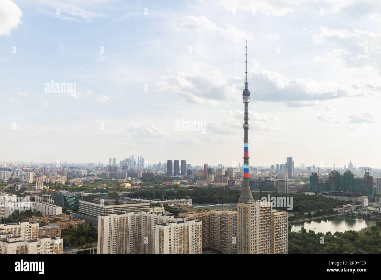 Ostankino TV Tower towering against the backdrop of many buildings in ...