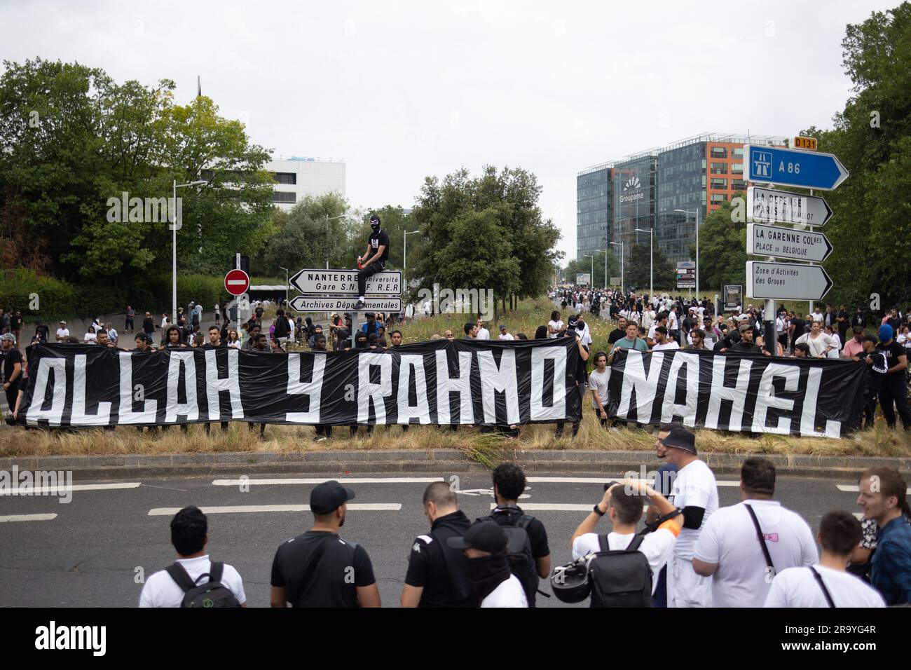 People hold a sign Allah y rahmo Nahel (may he rest in peace Nahel ...