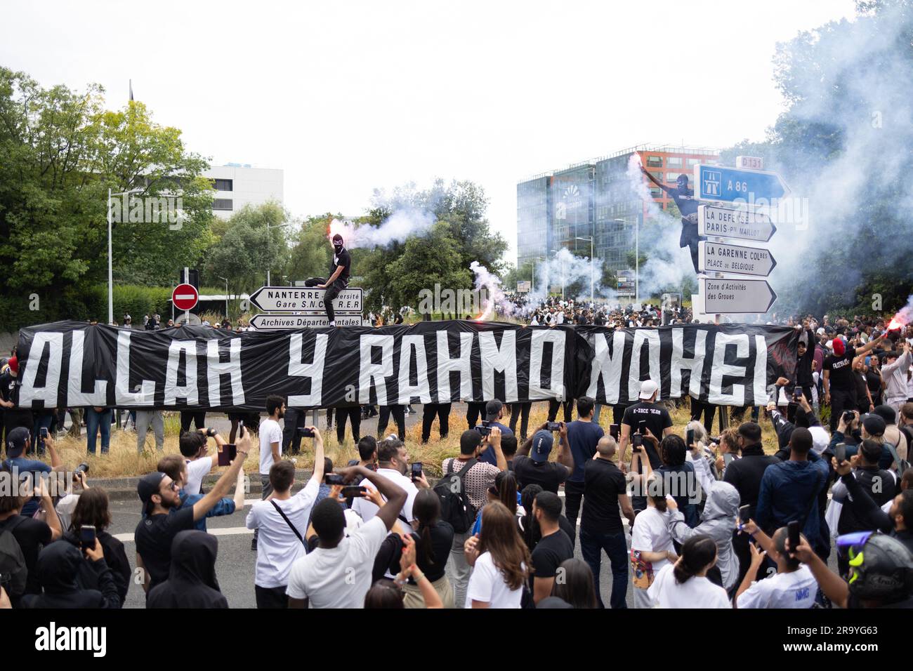 People hold a sign Allah y rahmo Nahel (may he rest in peace Nahel ...