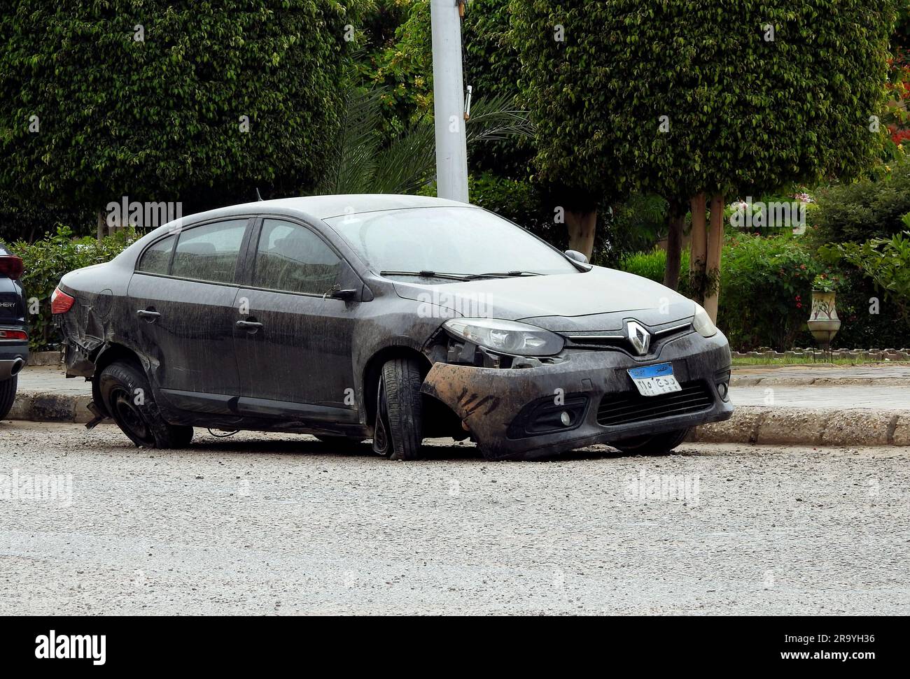 Cairo, Egypt, June 6 2023: Black wrecked car damaged by accident on the ...