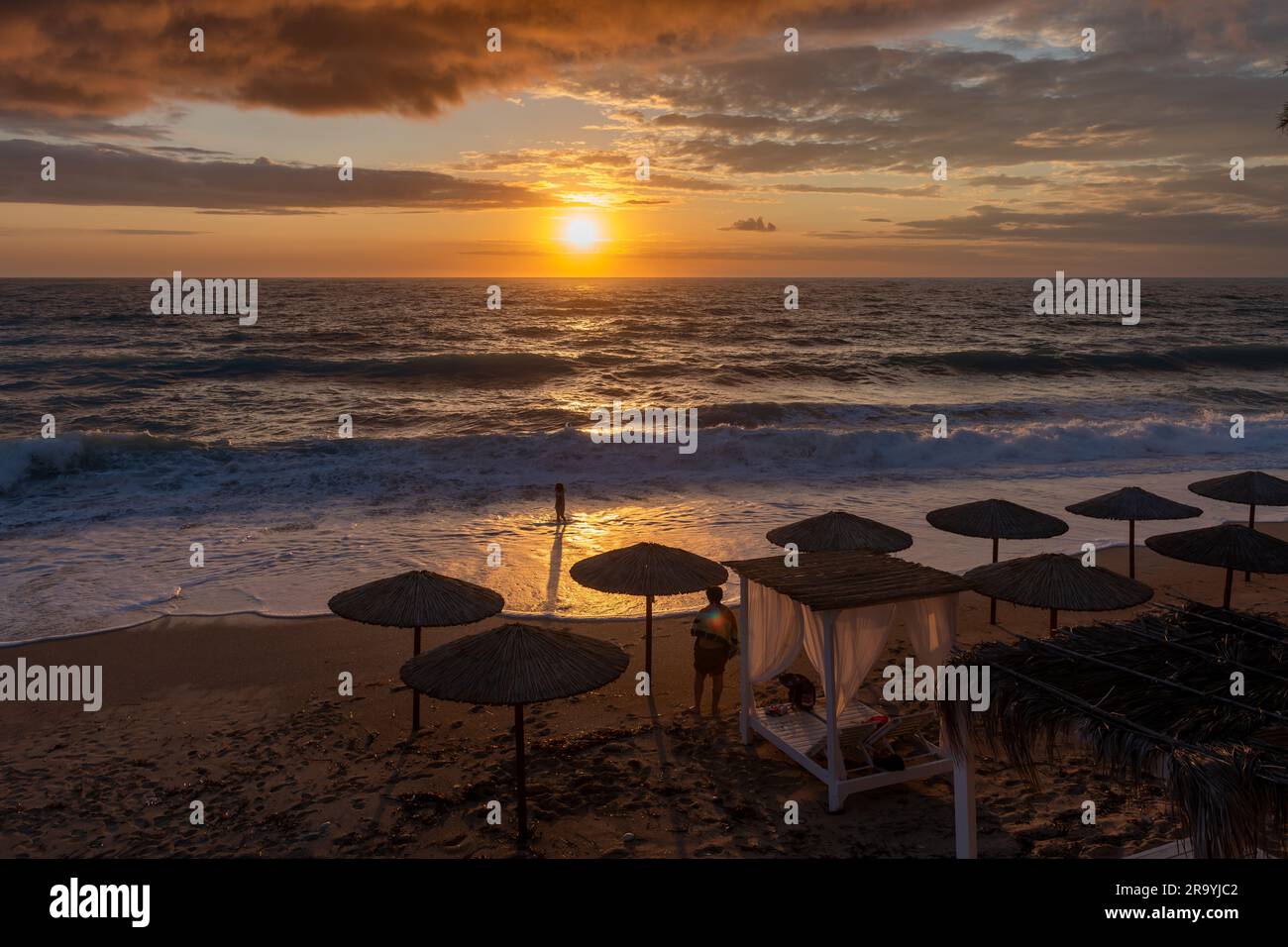 A sandy beach with holiday makers enjoying the sea and spectacular ...