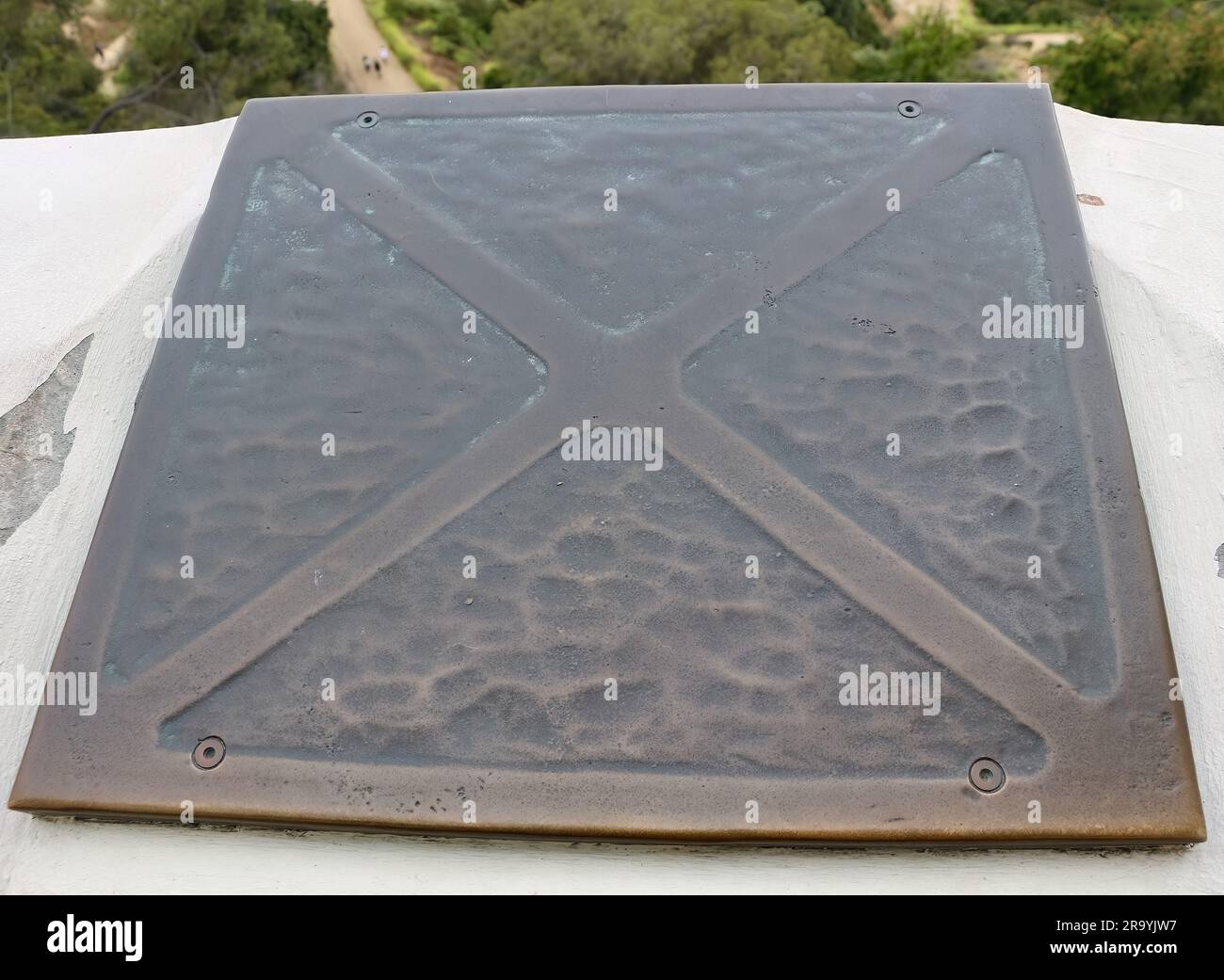 Square decorative bronze plaque with a cross riveted to the roof top ...