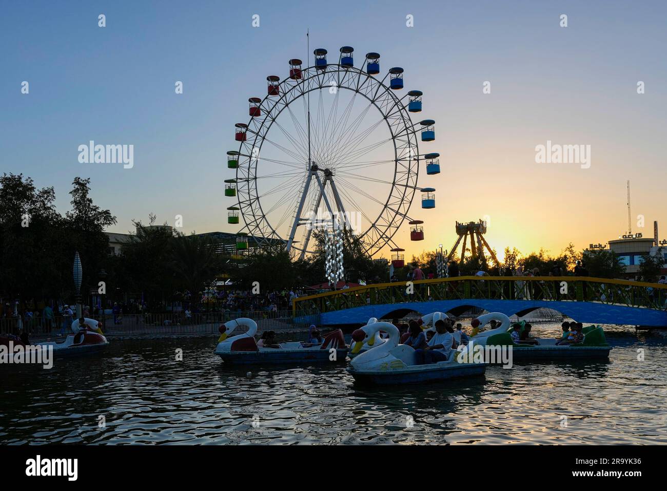 Iraqis enjoy rides at an amusement park during Eid al-Adha in Baghdad ...