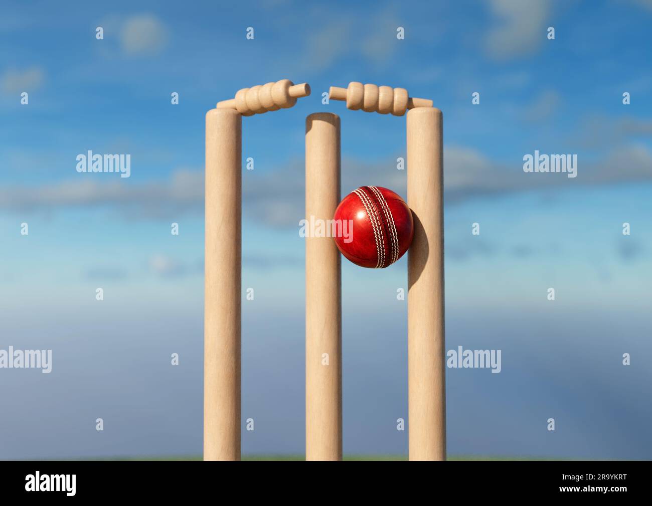 A red cricket ball striking wooden cricket wickets with dislodging ...