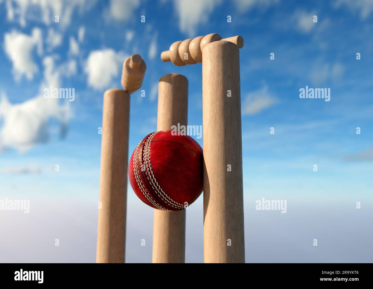 A red cricket ball striking wooden cricket wickets with dislodging ...