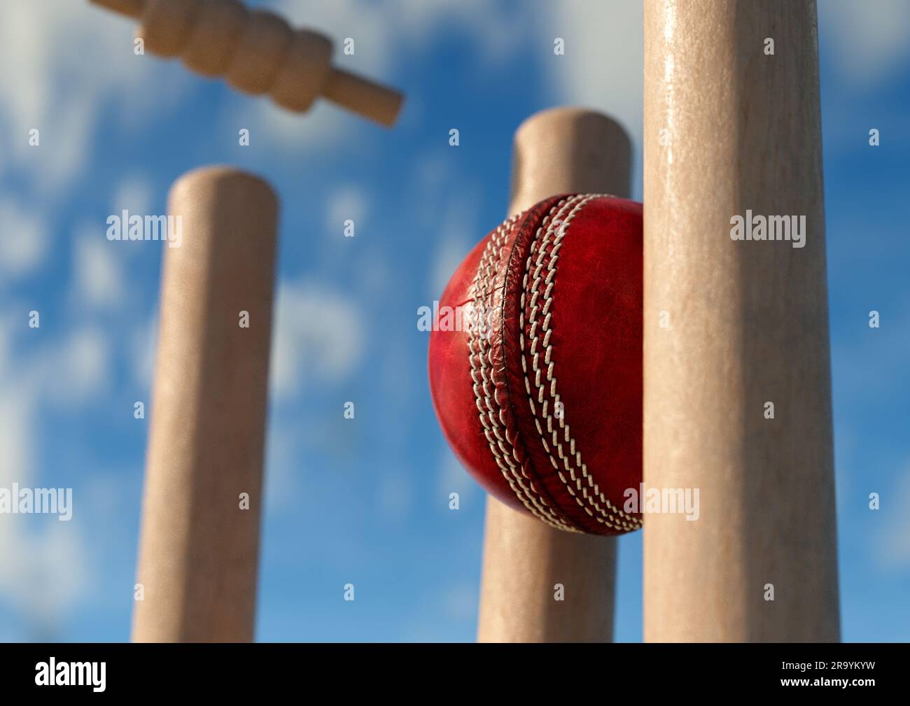 A red cricket ball striking wooden cricket wickets with dislodging ...