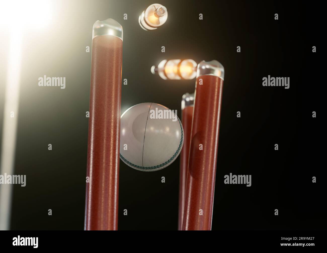 A white cricket ball striking orange electronic cricket wickets with ...