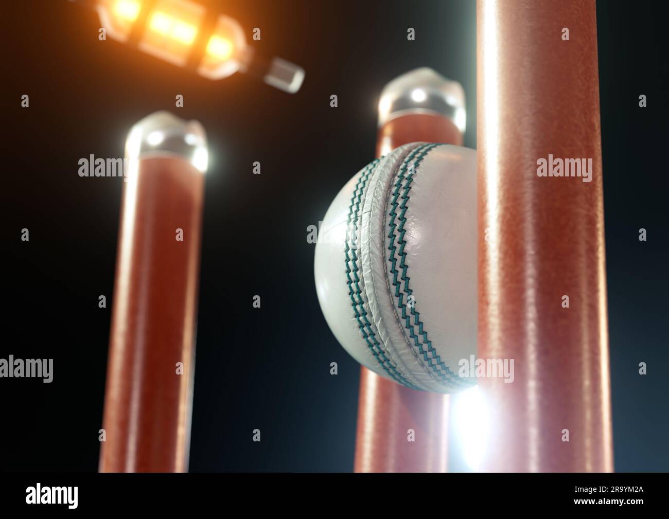 A white cricket ball striking orange electronic cricket wickets with ...