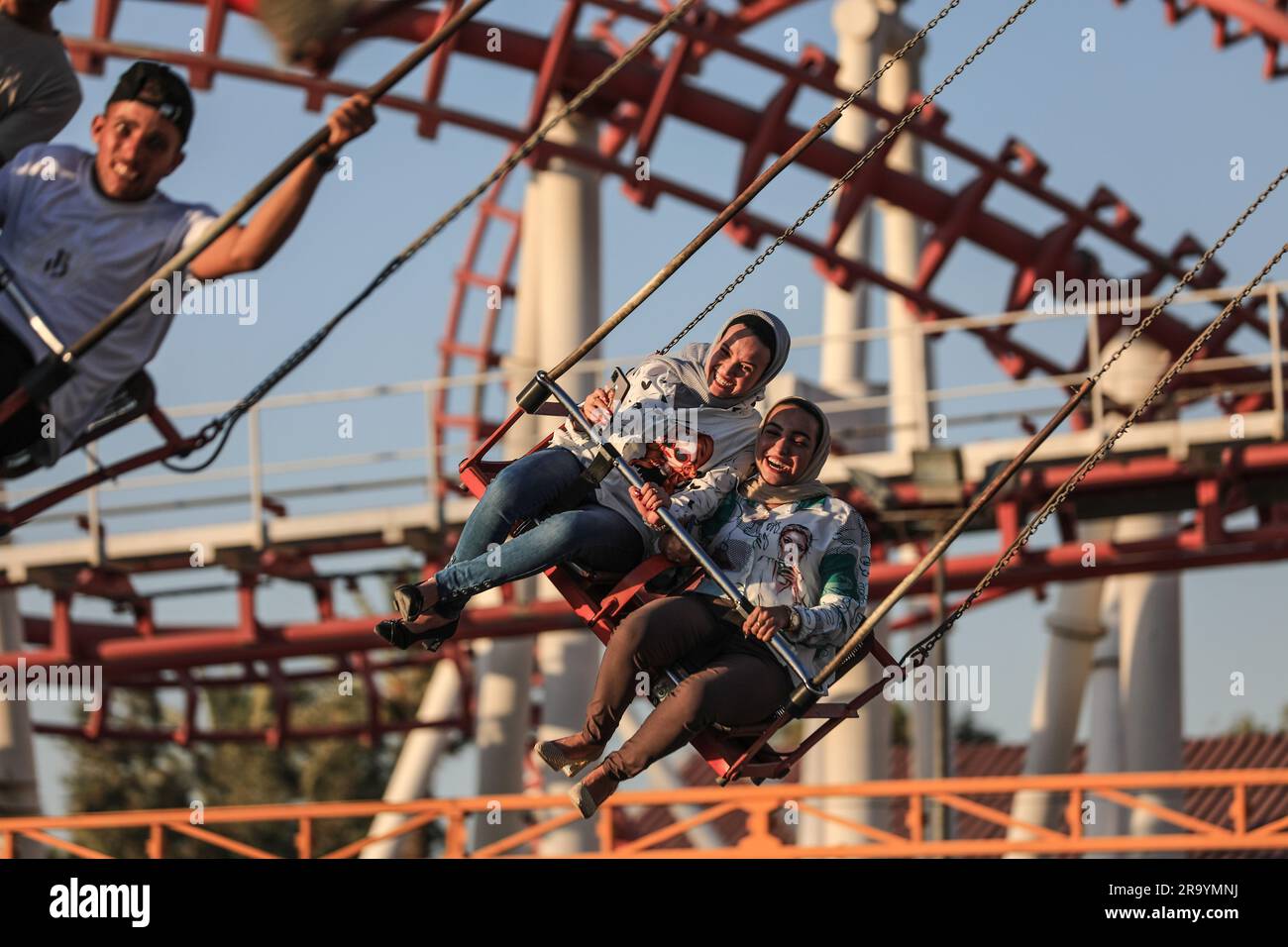 Baghdad, Iraq. 29th June, 2023. People ride on a swing carousel at Al ...