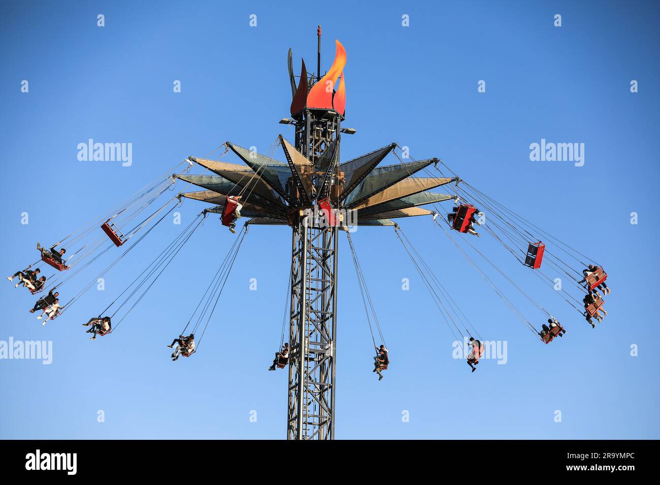 Baghdad, Iraq. 29th June, 2023. People ride on a swing carousel at Al ...