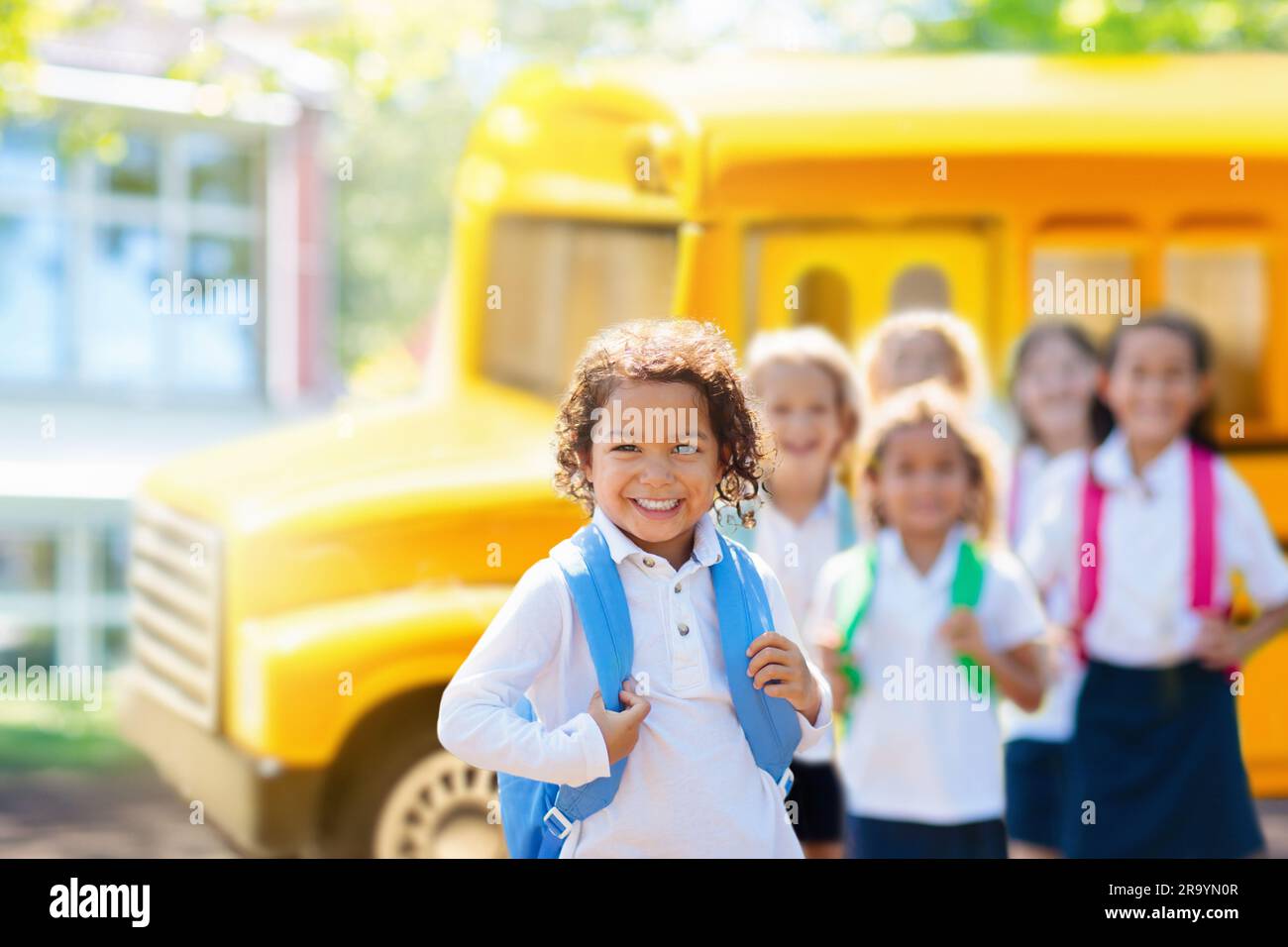 Kids go back to school on bus. Interracial group of children of mixed ...