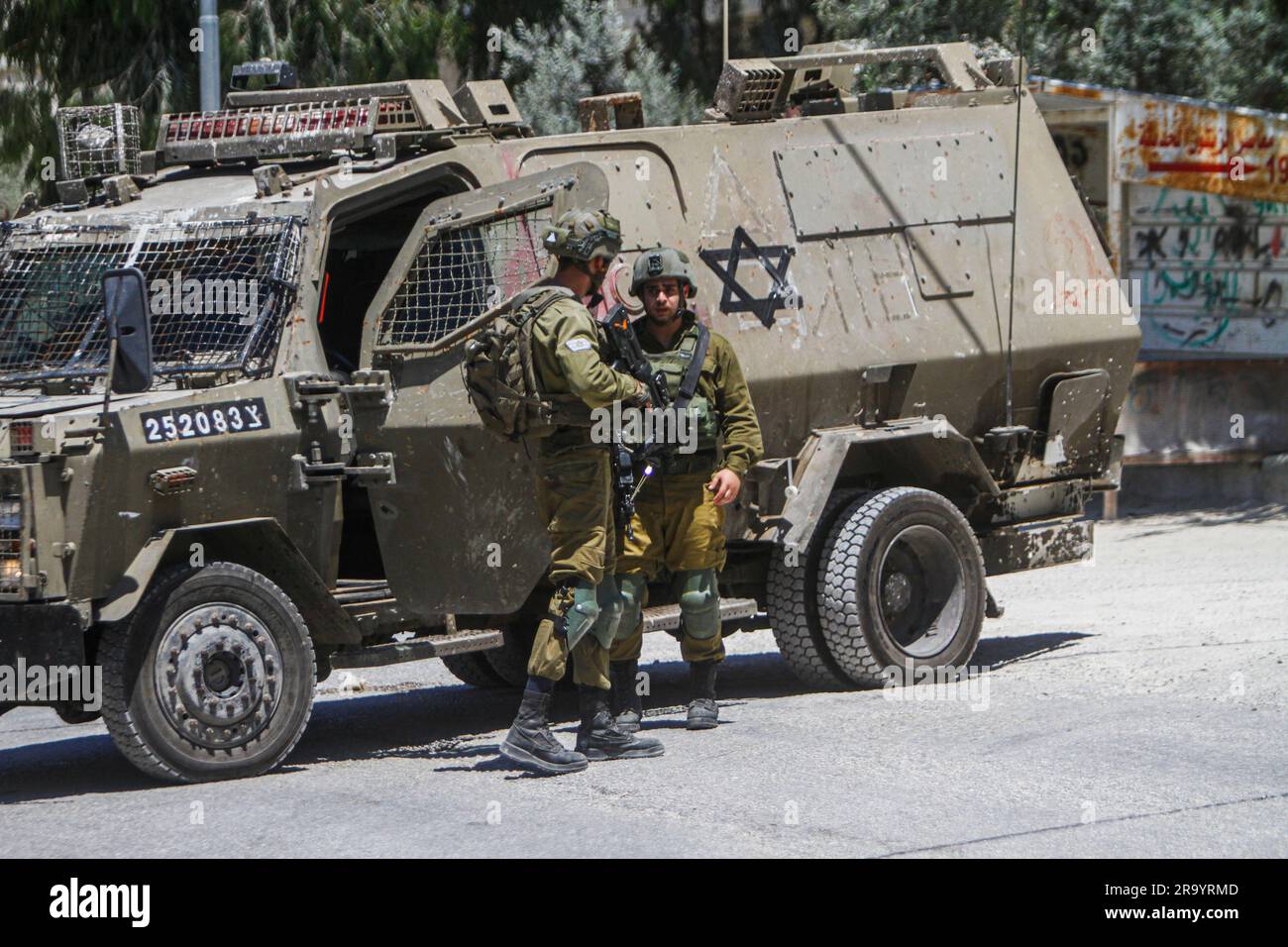 Nablus, Palestine. 29th June, 2023. An Israeli soldier guards the ...