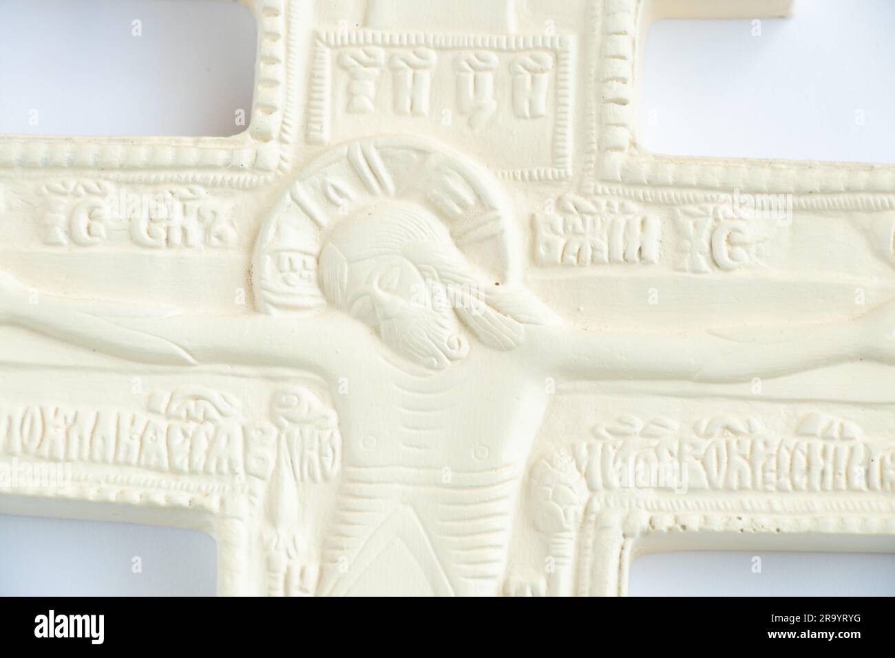 Christian plaster cross on a white background close-up Stock Photo - Alamy