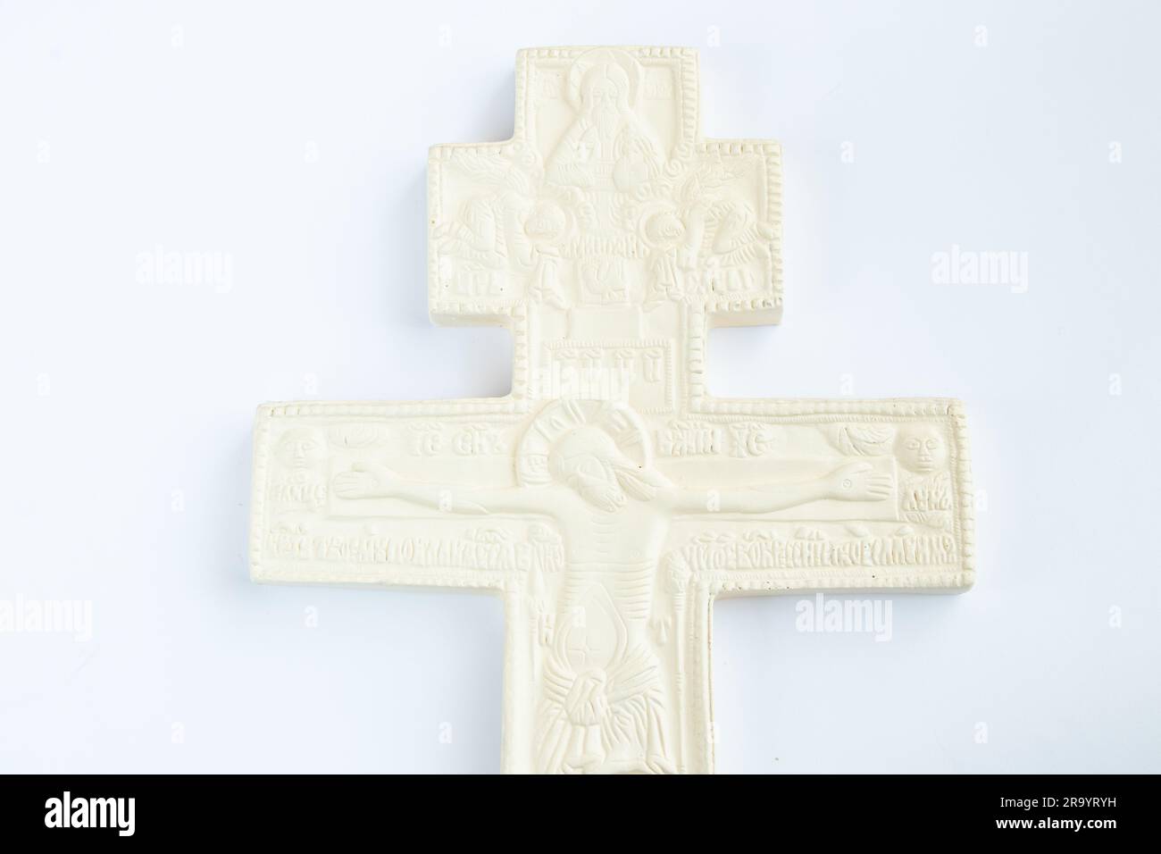 Christian plaster cross on a white background close-up Stock Photo - Alamy