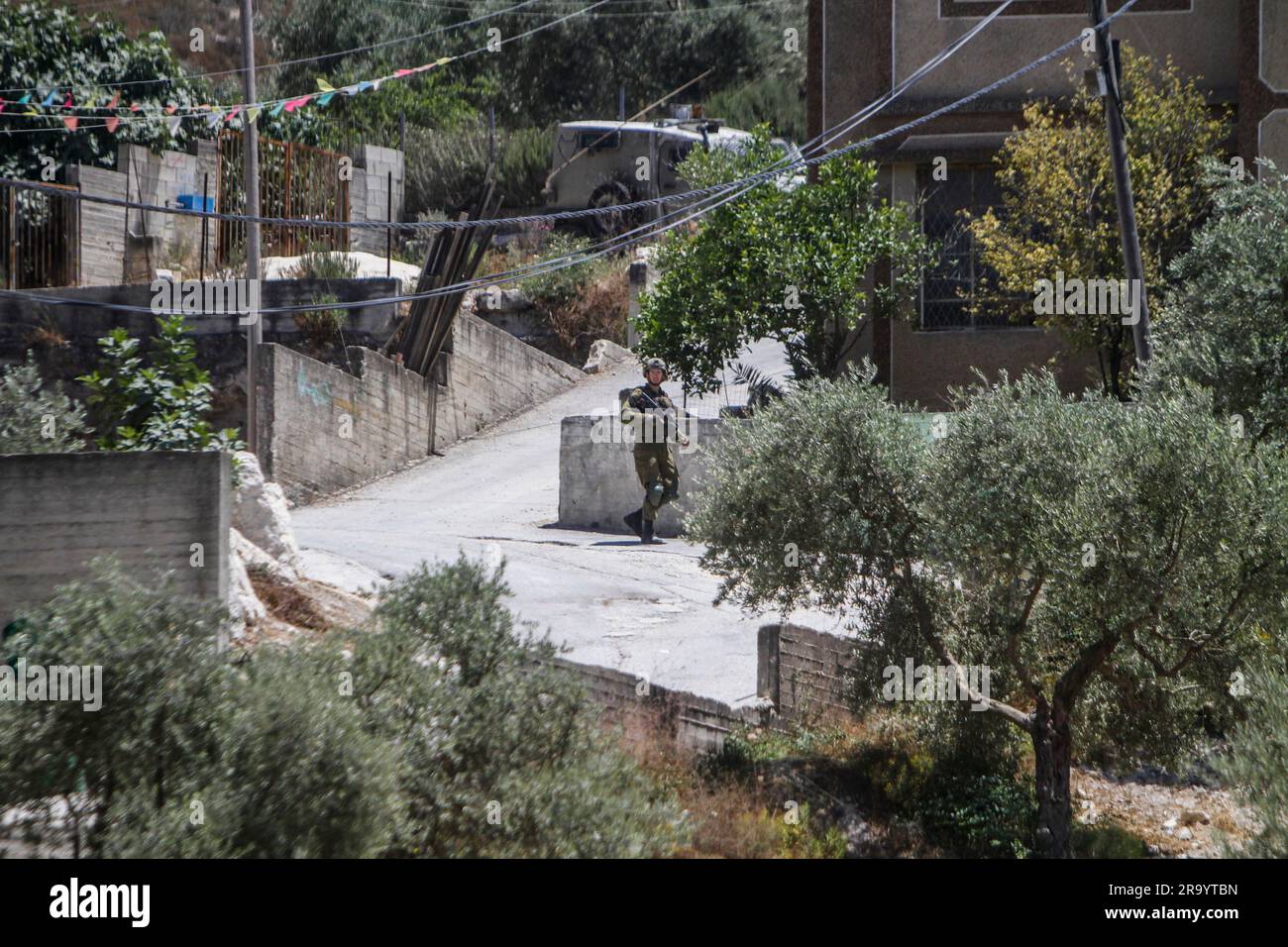 Nablus, Palestine. 29th June, 2023. An Israeli soldier surrounds a ...