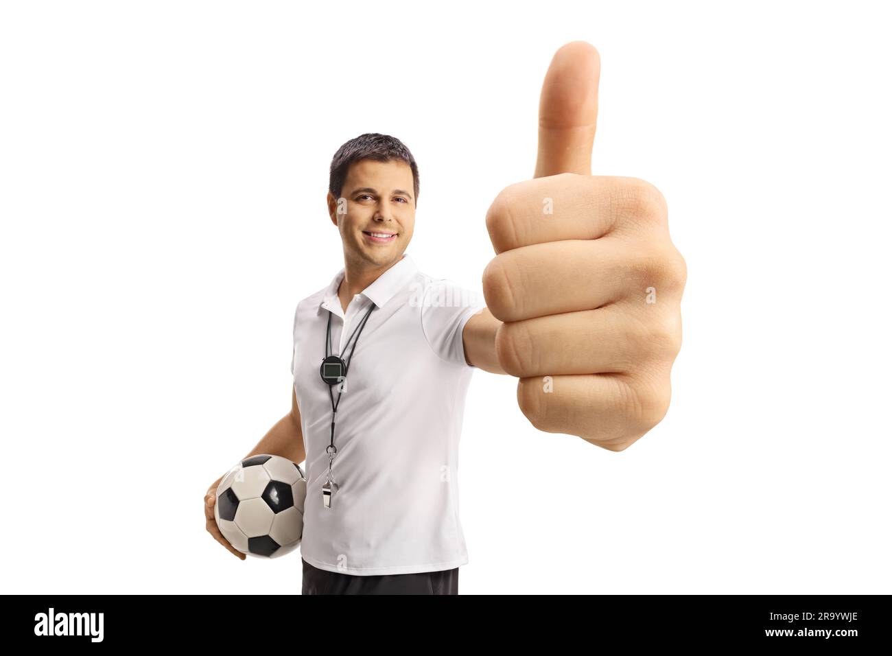 Football coach holding a ball and gesturing thumbs up isolated on white ...
