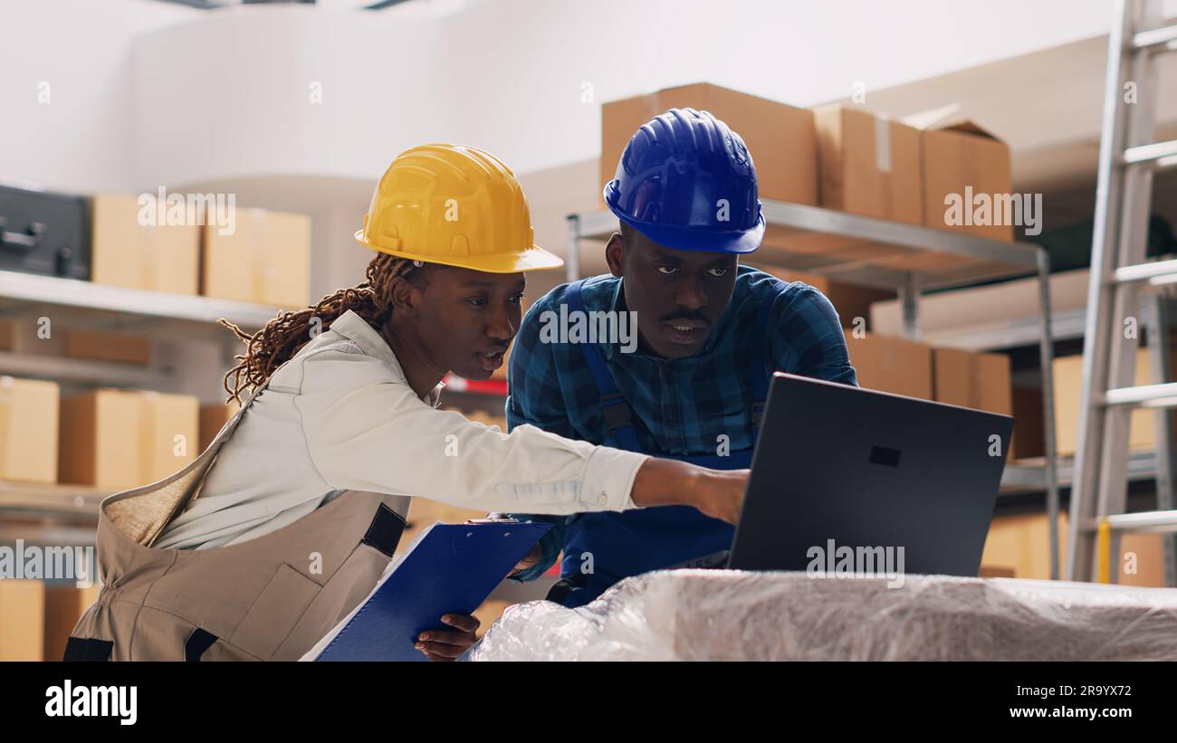 Female supervisor doing quality control in storehouse, working with ...