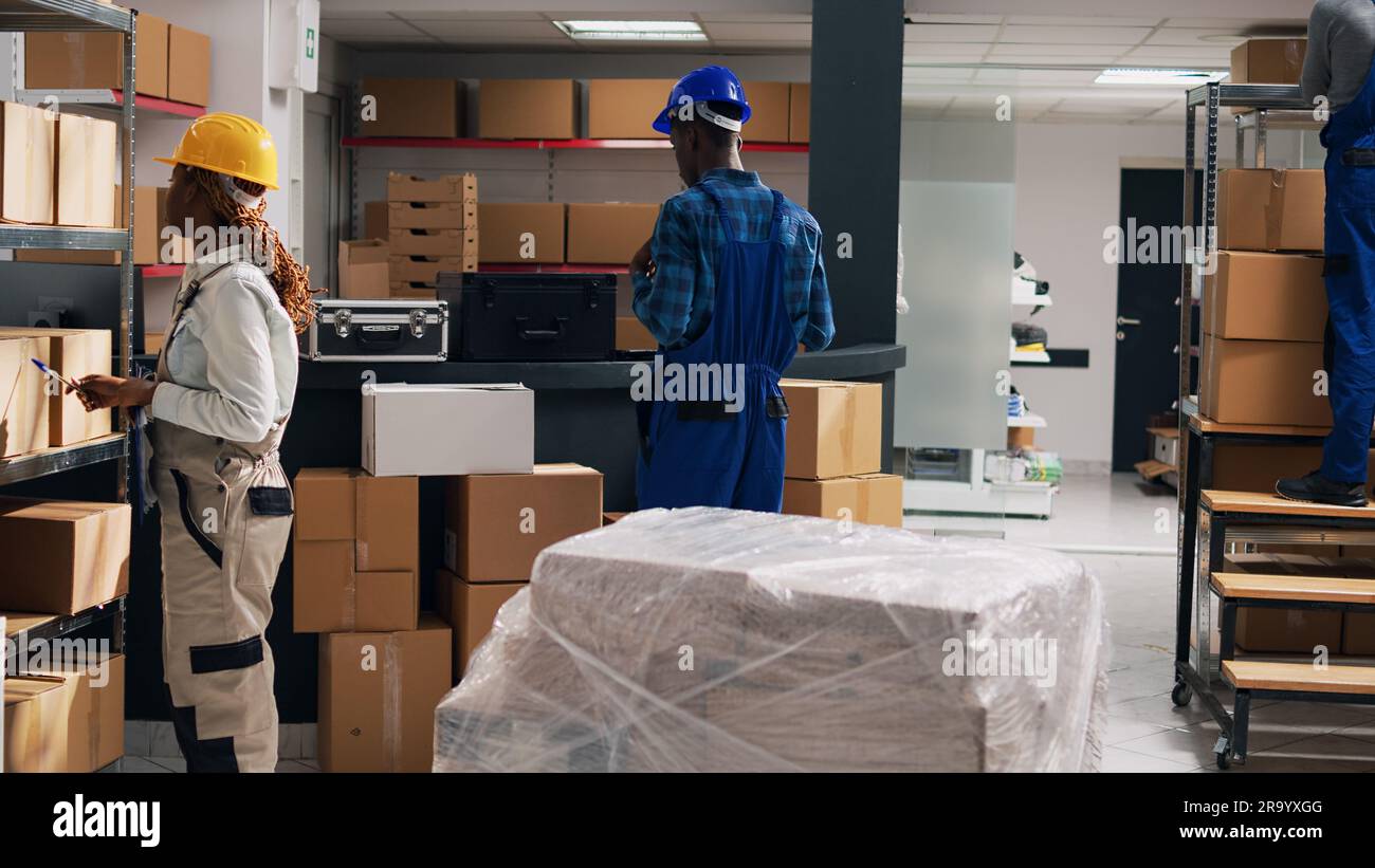 Young logistics checking merchandise manager hi-res stock photography ...
