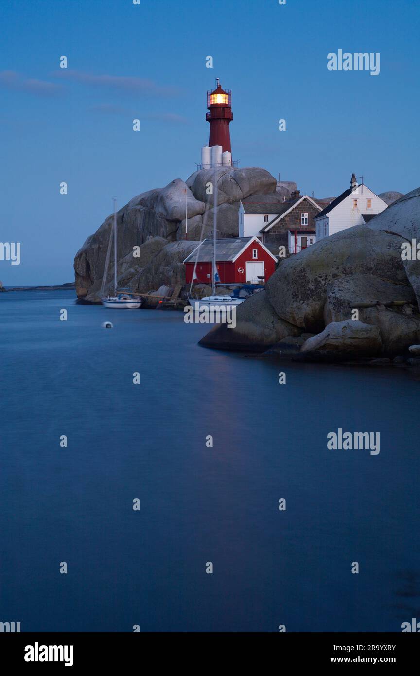 Calm and peaceful sea with houses and lighthouse in the background at ...