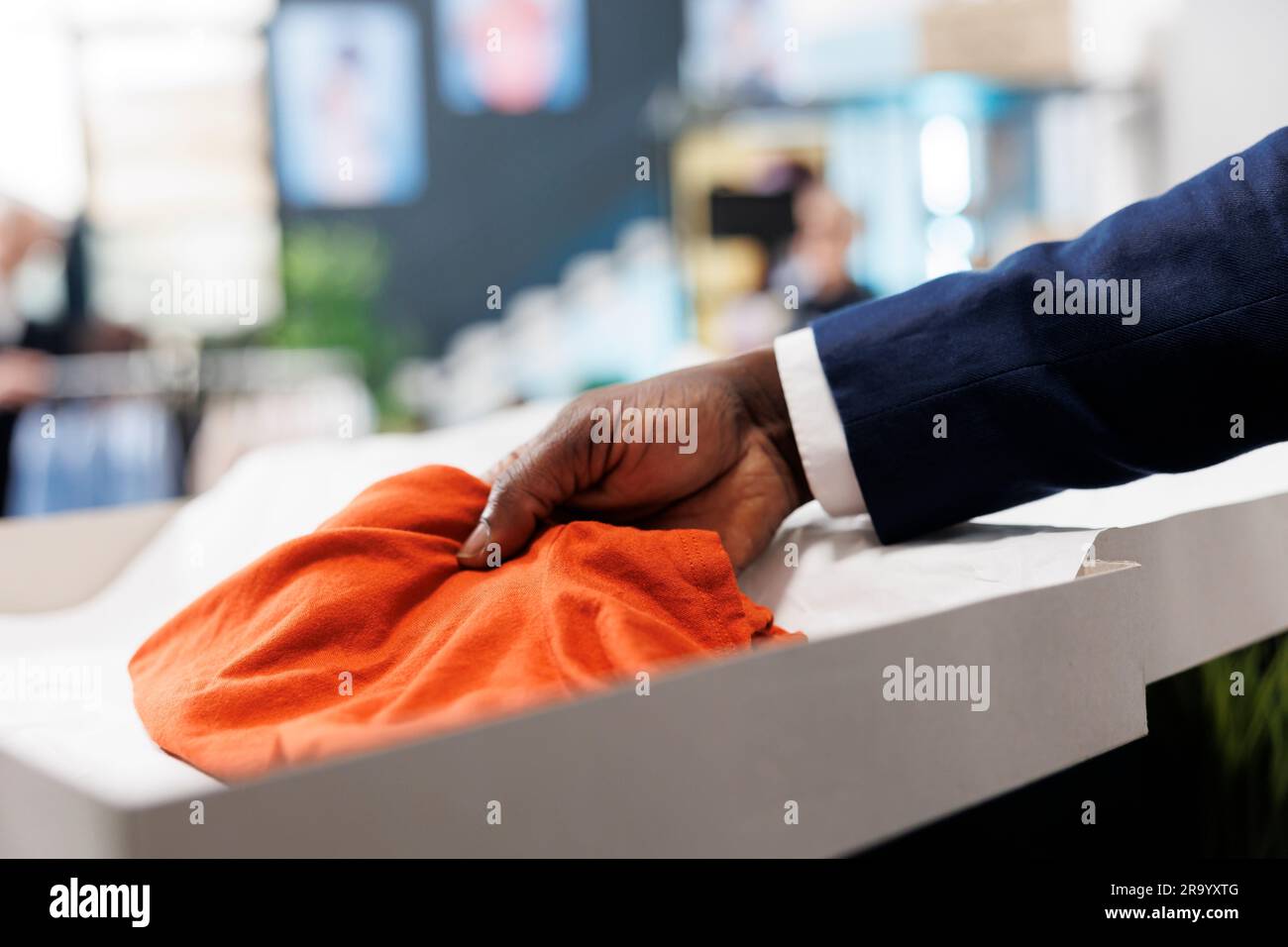 African american store manager preparing clients packages, putting ...