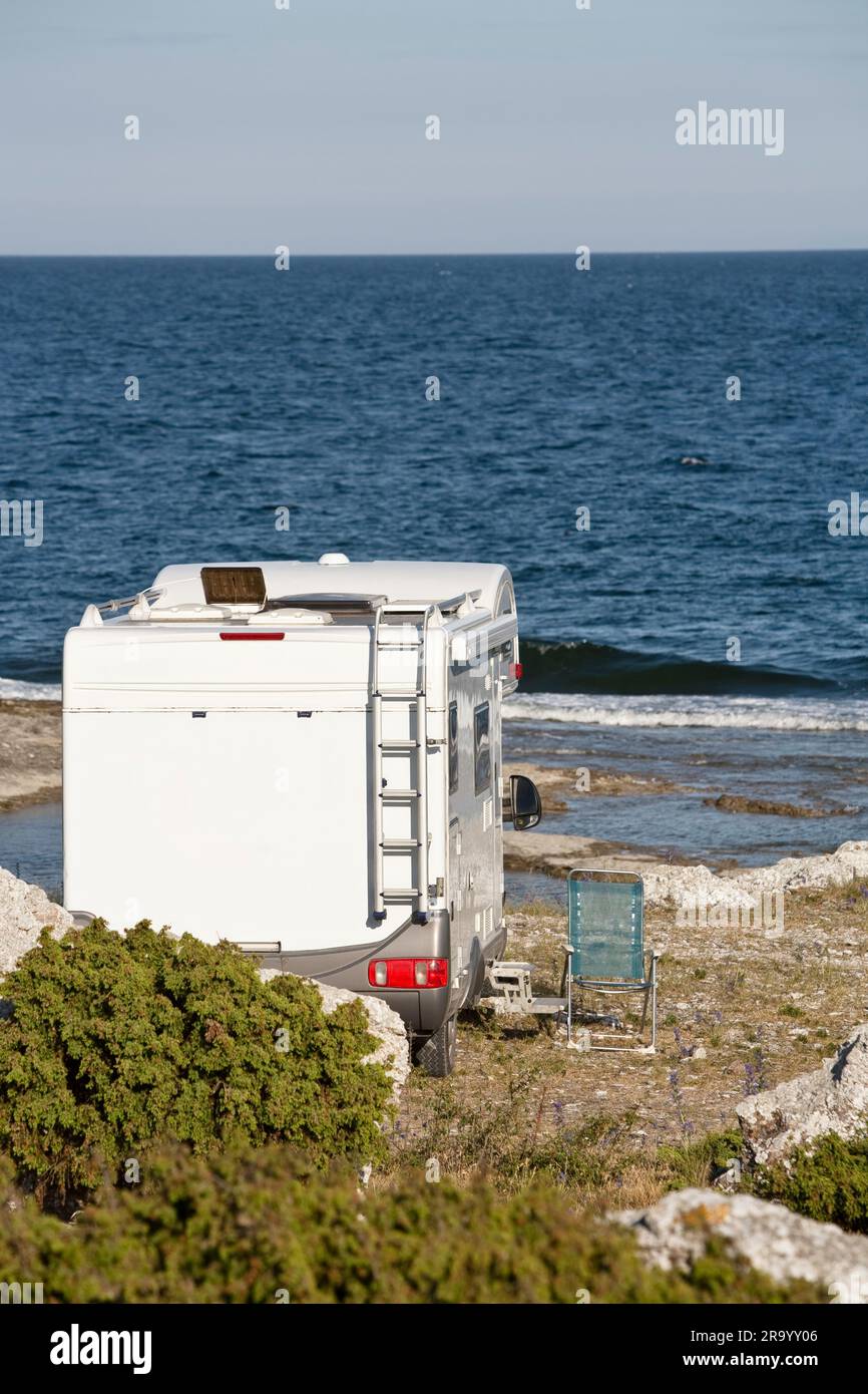 Back view of a motor home camped on beach by the sea. Gotland island ...
