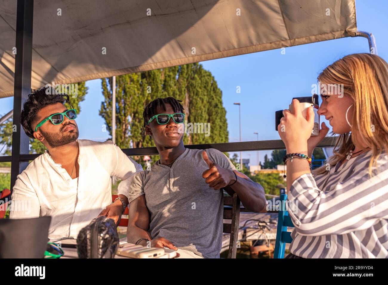 small group of multiethnic friends having fun taking photographs with a ...