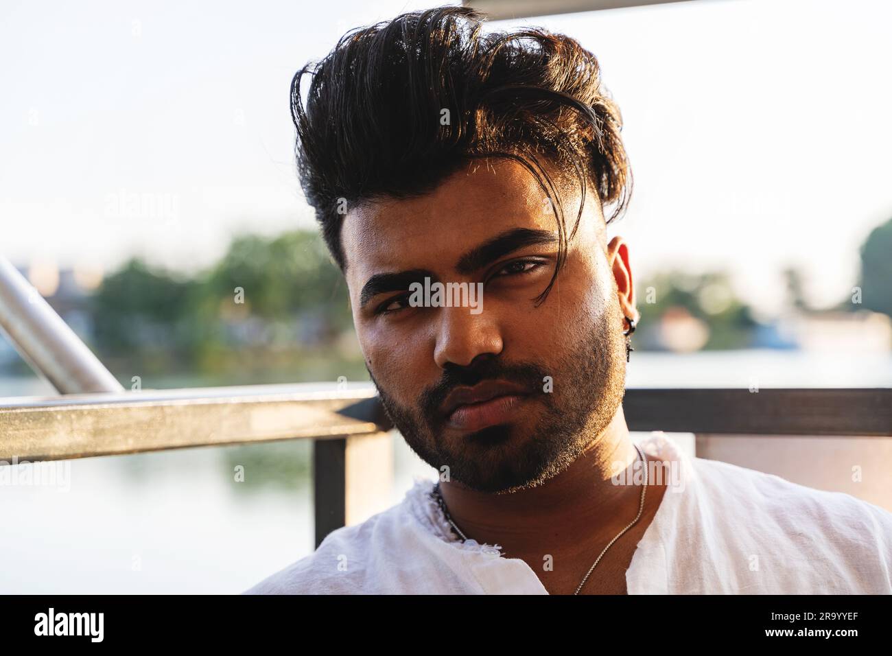 portrait of young handsome pakistani man sitting on boat sailing during ...