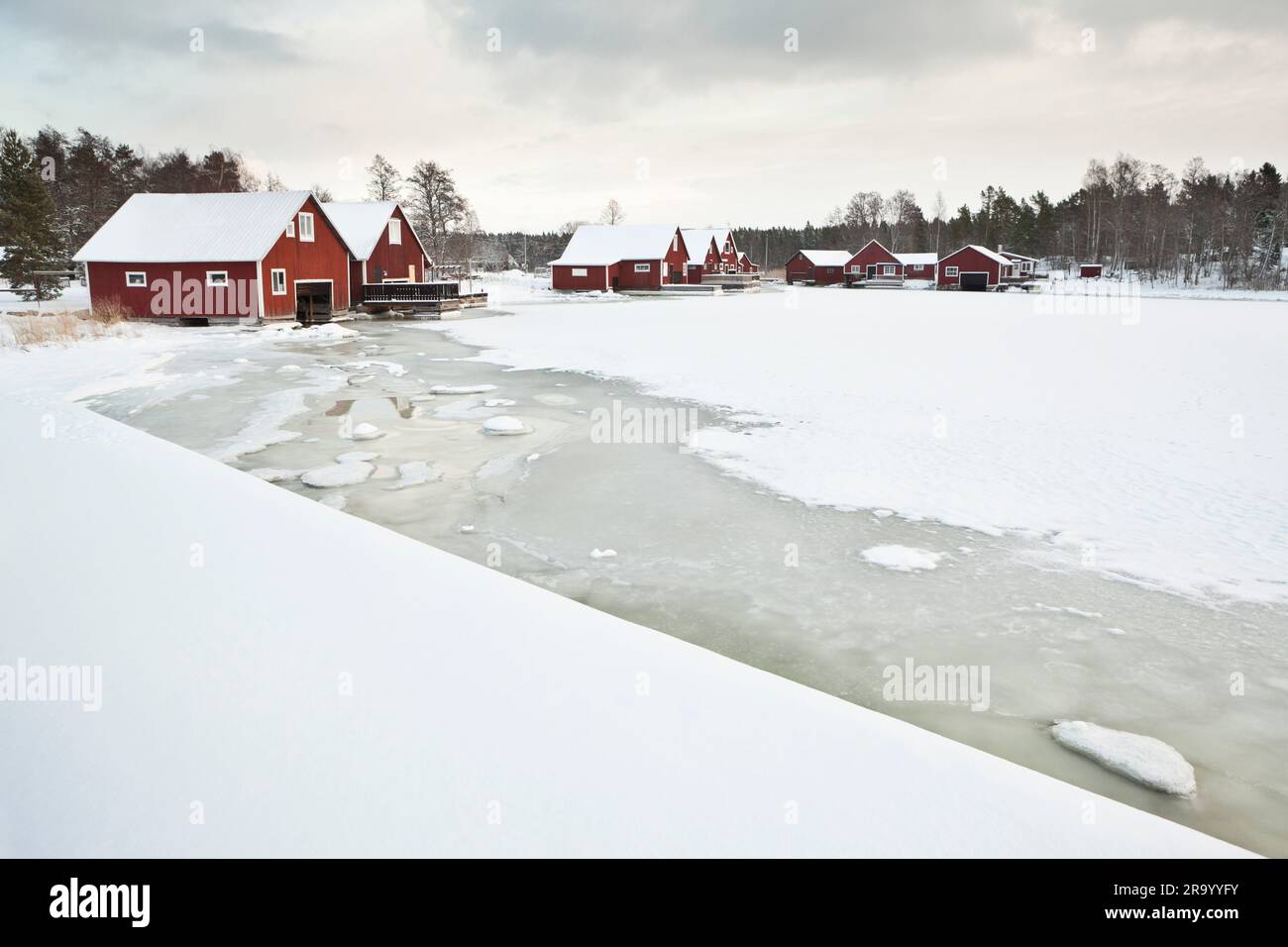 Cottages and snow covered landscape at deserted fishing village in ...