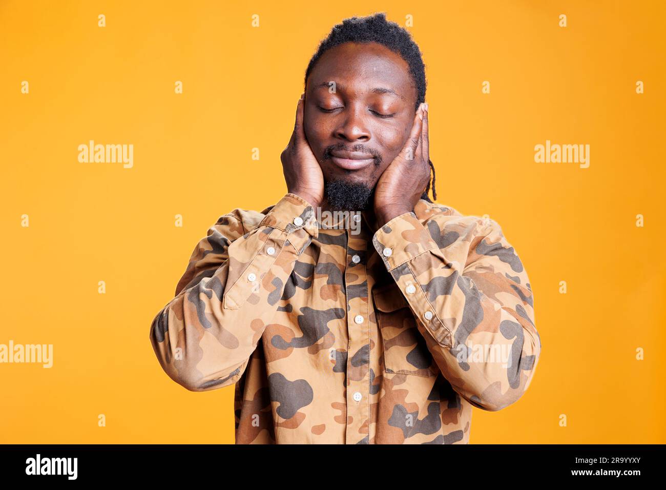 Man with close eyes covering ears with palms, doing three wise monkeys ... Man with close eyes covering ears with palms, doing three wise monkeys ...