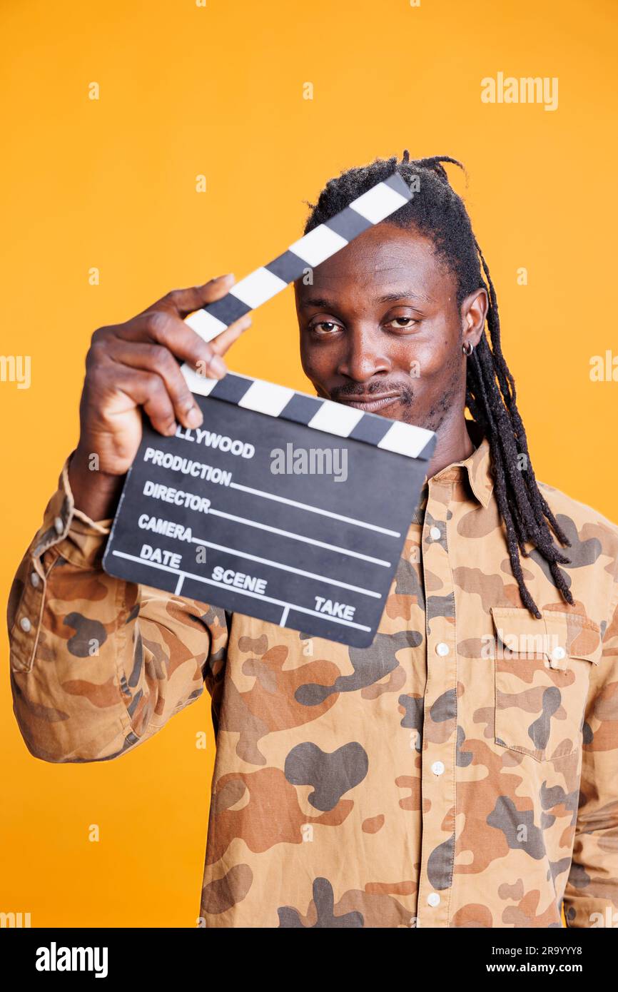 Attractive film director holding clipper board to cut scenes in movie ...