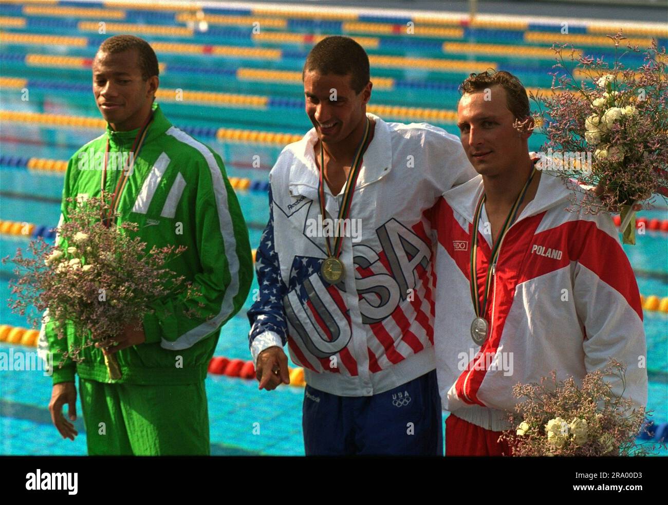 FILE - Pablo Morales, center, from the UnitesStates, displays the gold ...