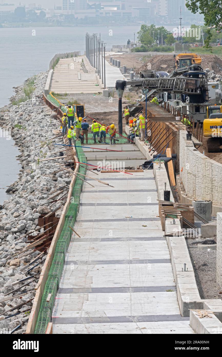 Detroit, Michigan - Workers pour cement to complete a section of the ...