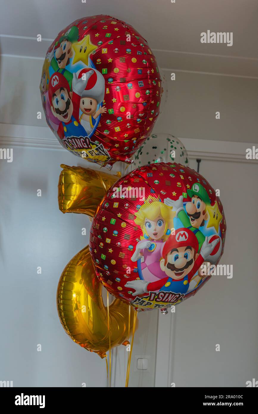 Close-up view of big helium balloons with cartoon characters on white ...