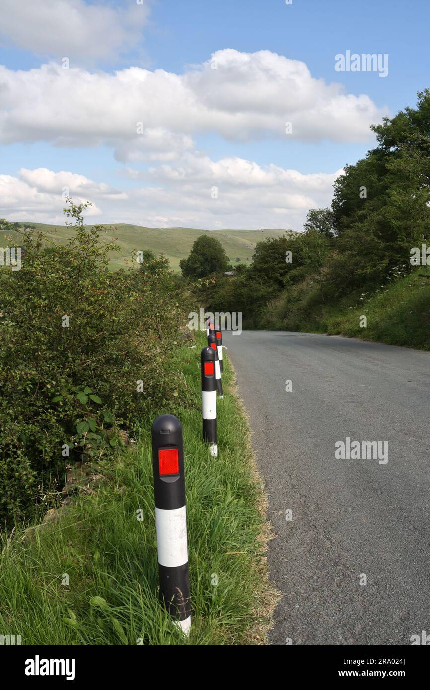 Black and white stripped bollards, side of the road in England ...