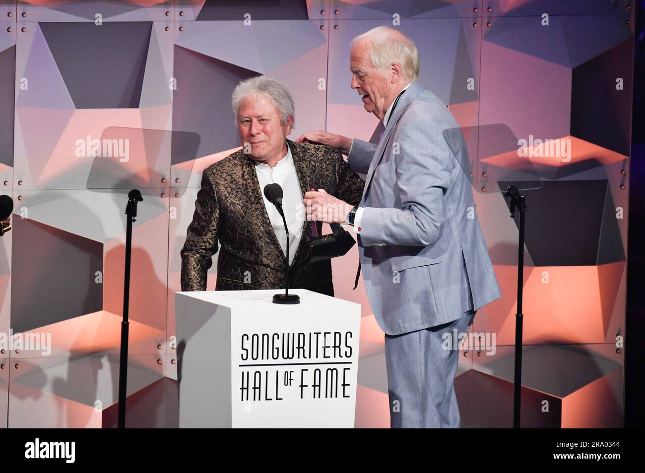 Alan Menken, left, presents the Johnny Mercer award to Tim Rice at the ...