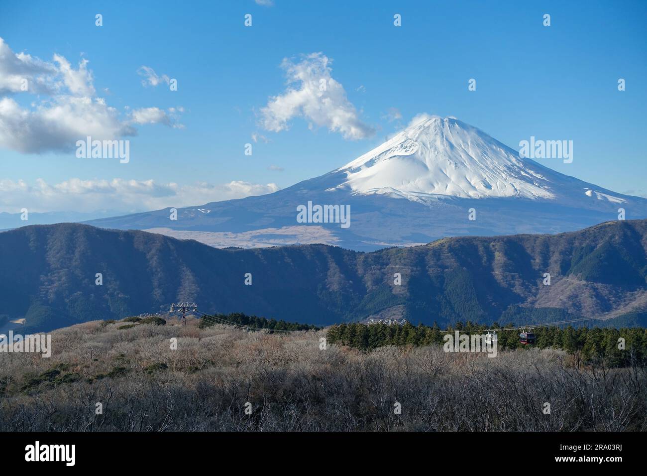 Snow-capped cone-shaped Mount Fuji and the Owakudani cablecar seen from ...