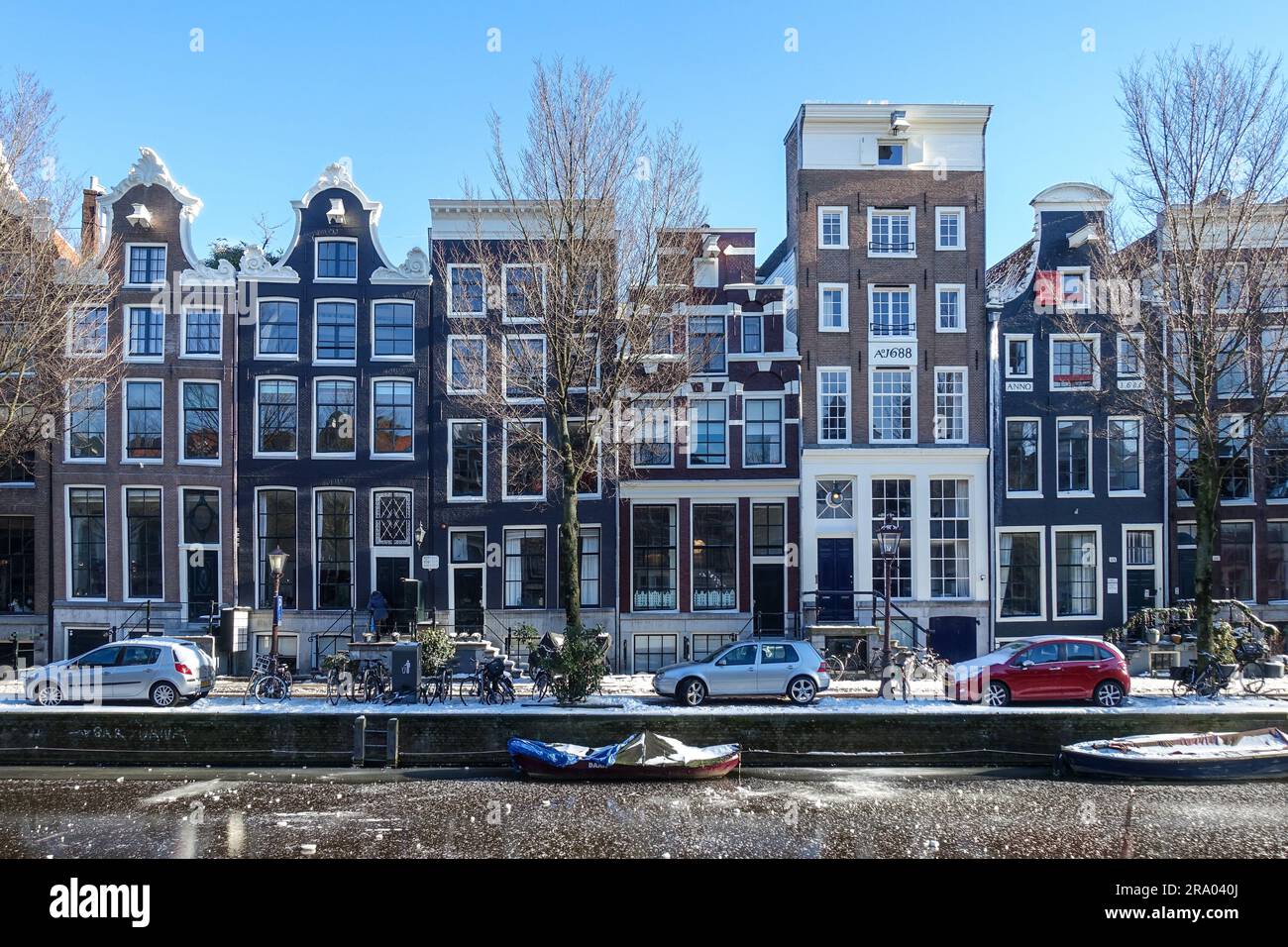 Boats on the frozen canals of Amsterdam during a cold winter day of ...