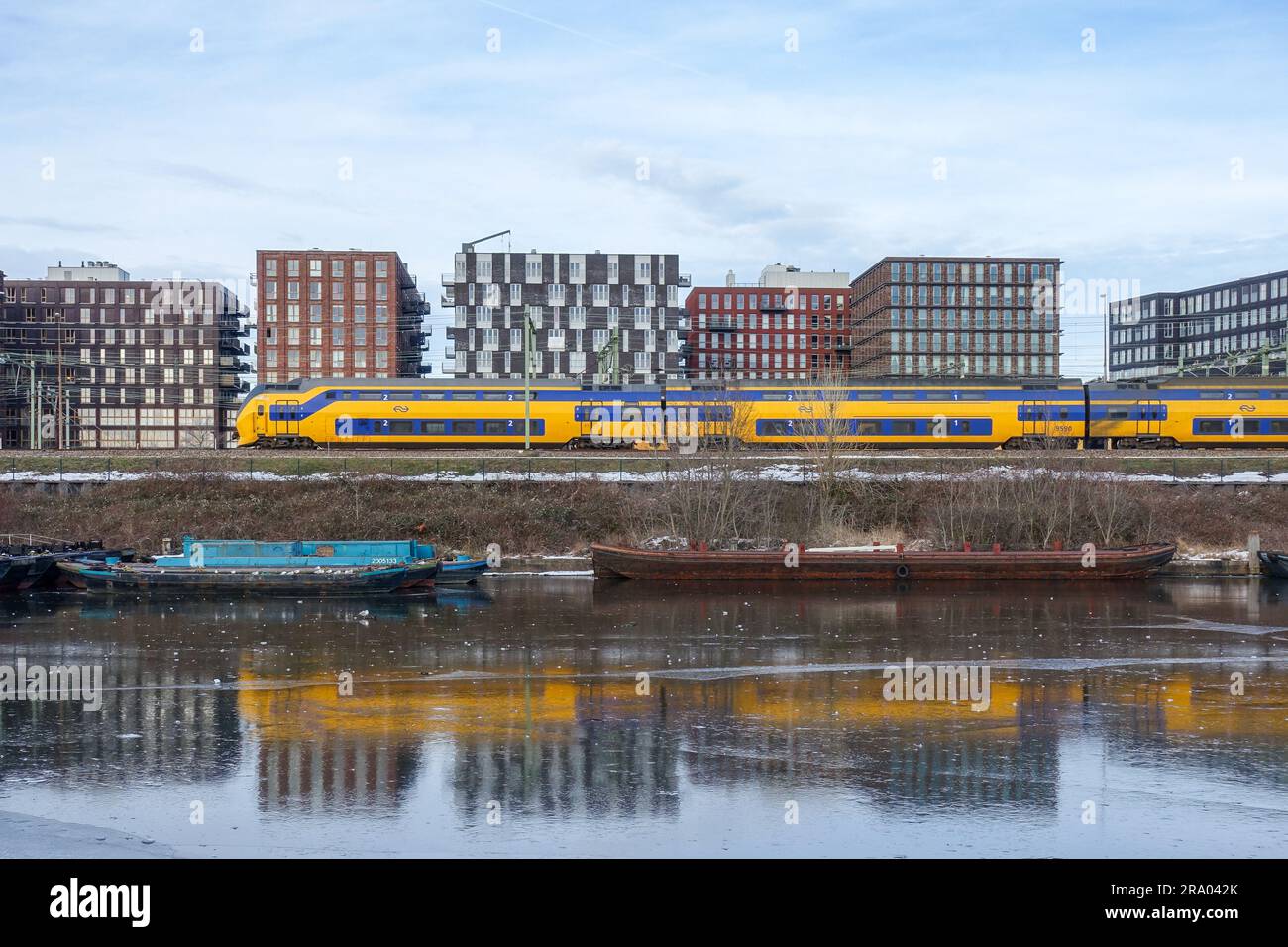NS train (Netherlands) reflecting over frozen canals in Amsterdam Stock ...
