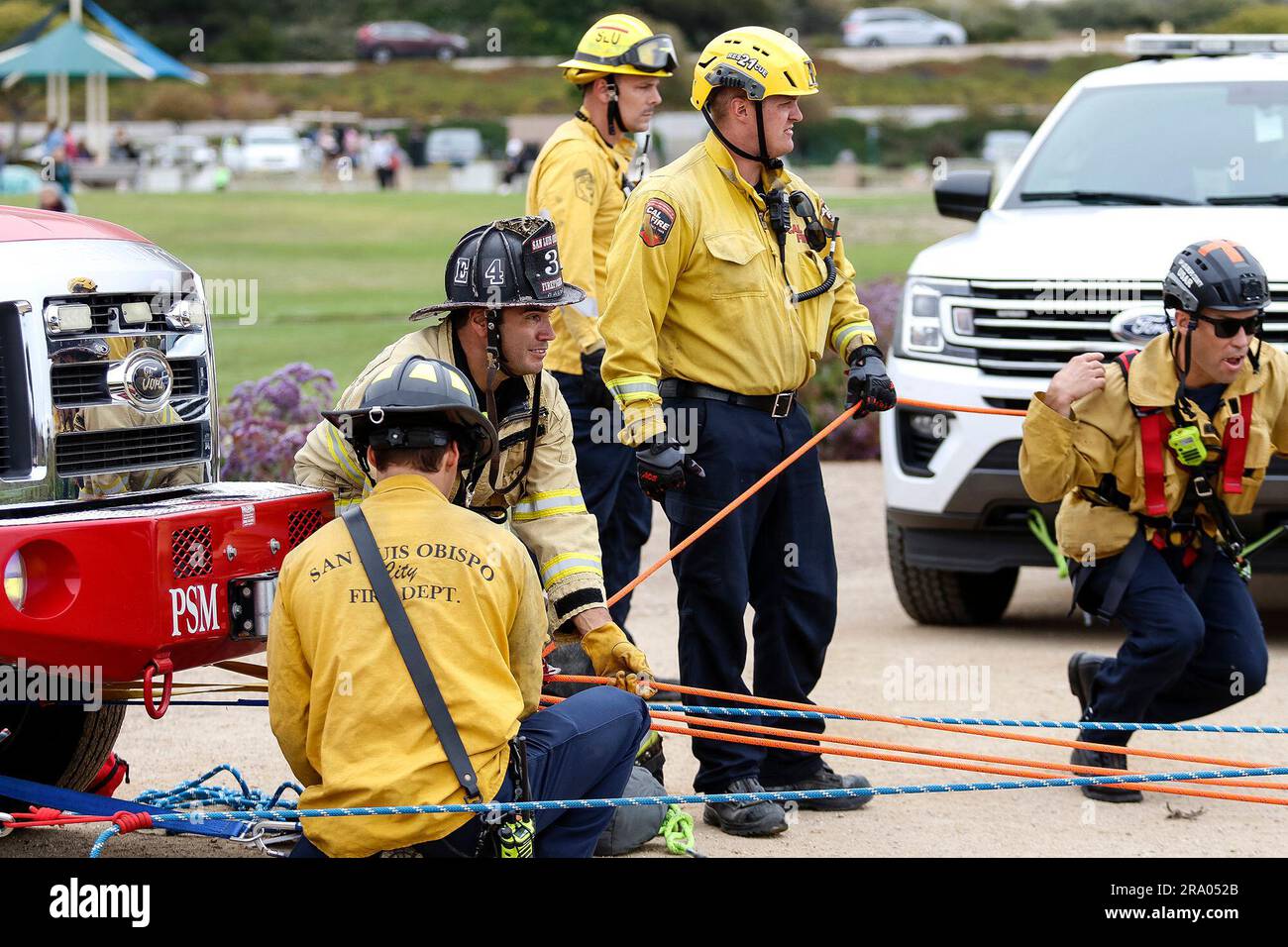 Firefighter cinch up the ropes leading to the firefighters who repelled ...